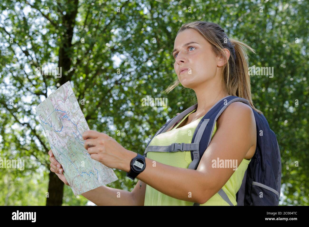 young woman backpacker checking her map Stock Photo - Alamy