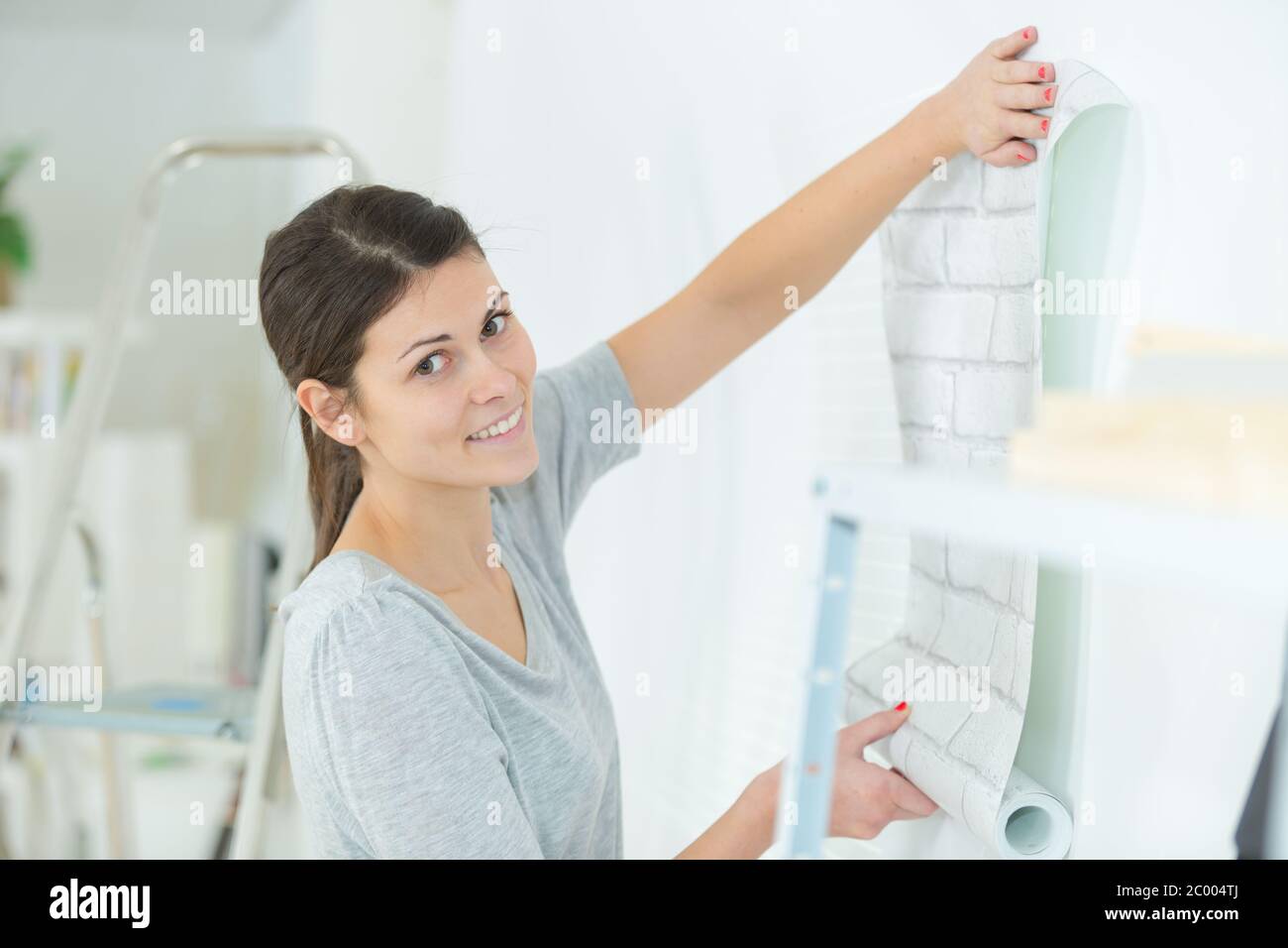 Putting wall paper hi-res stock photography and images - Alamy