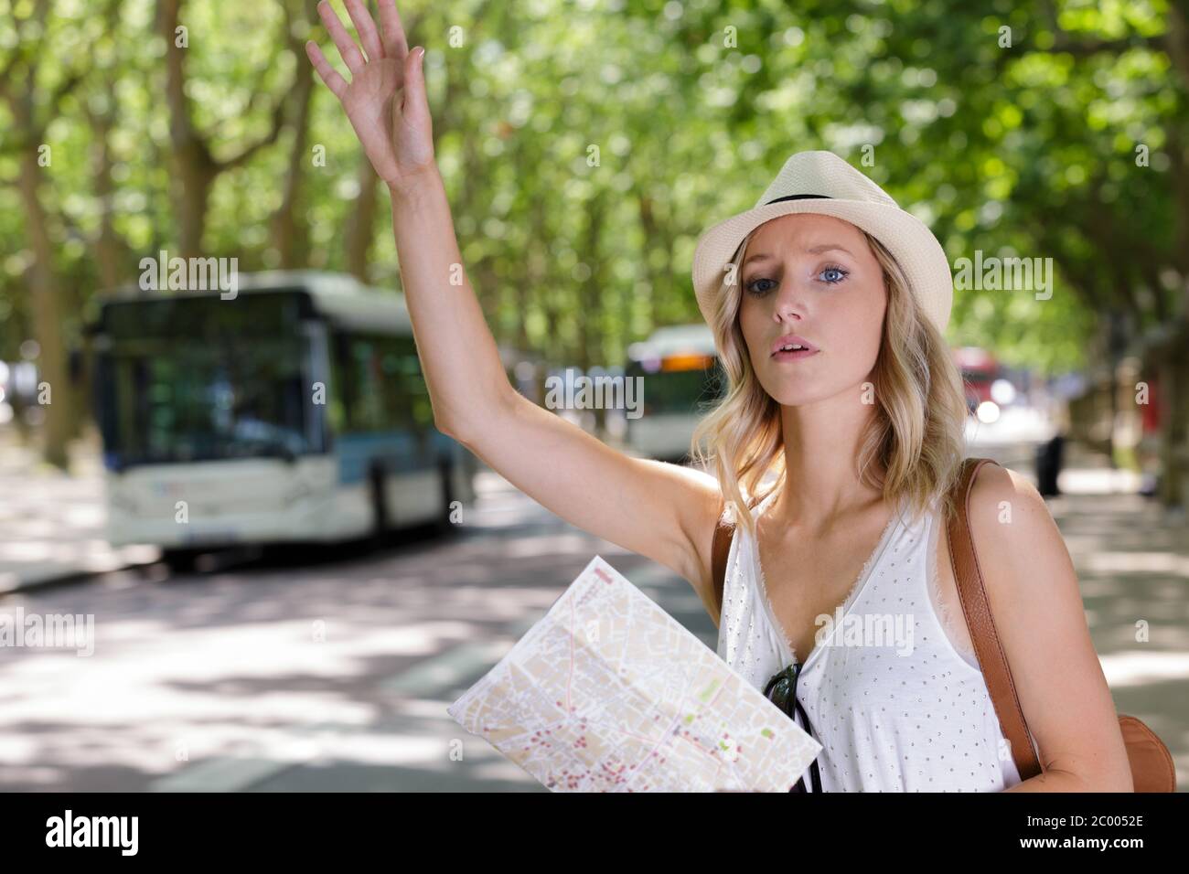 beautiful woman hailing public transport Stock Photo - Alamy