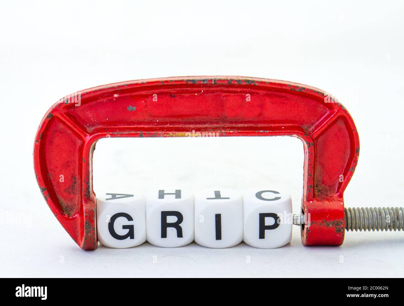 The word grip isolated in a red metal clamp - conceptual image isolated ...
