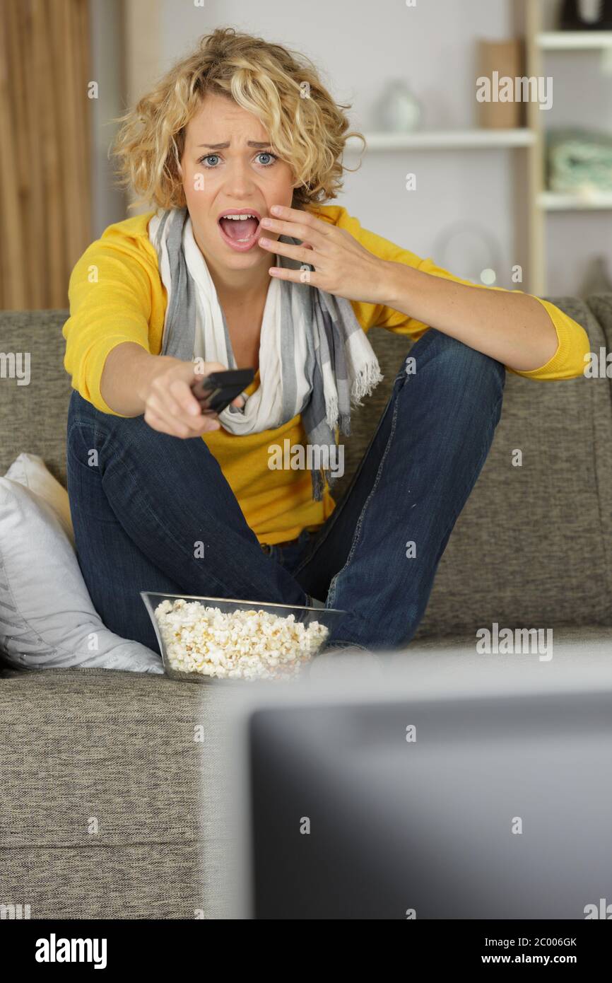 pretty woman upset about watching tv Stock Photo - Alamy