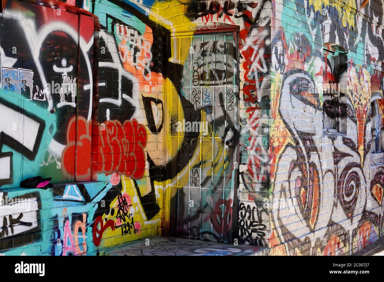Colorful graffiti covers the outside of a house Stock Photo - Alamy