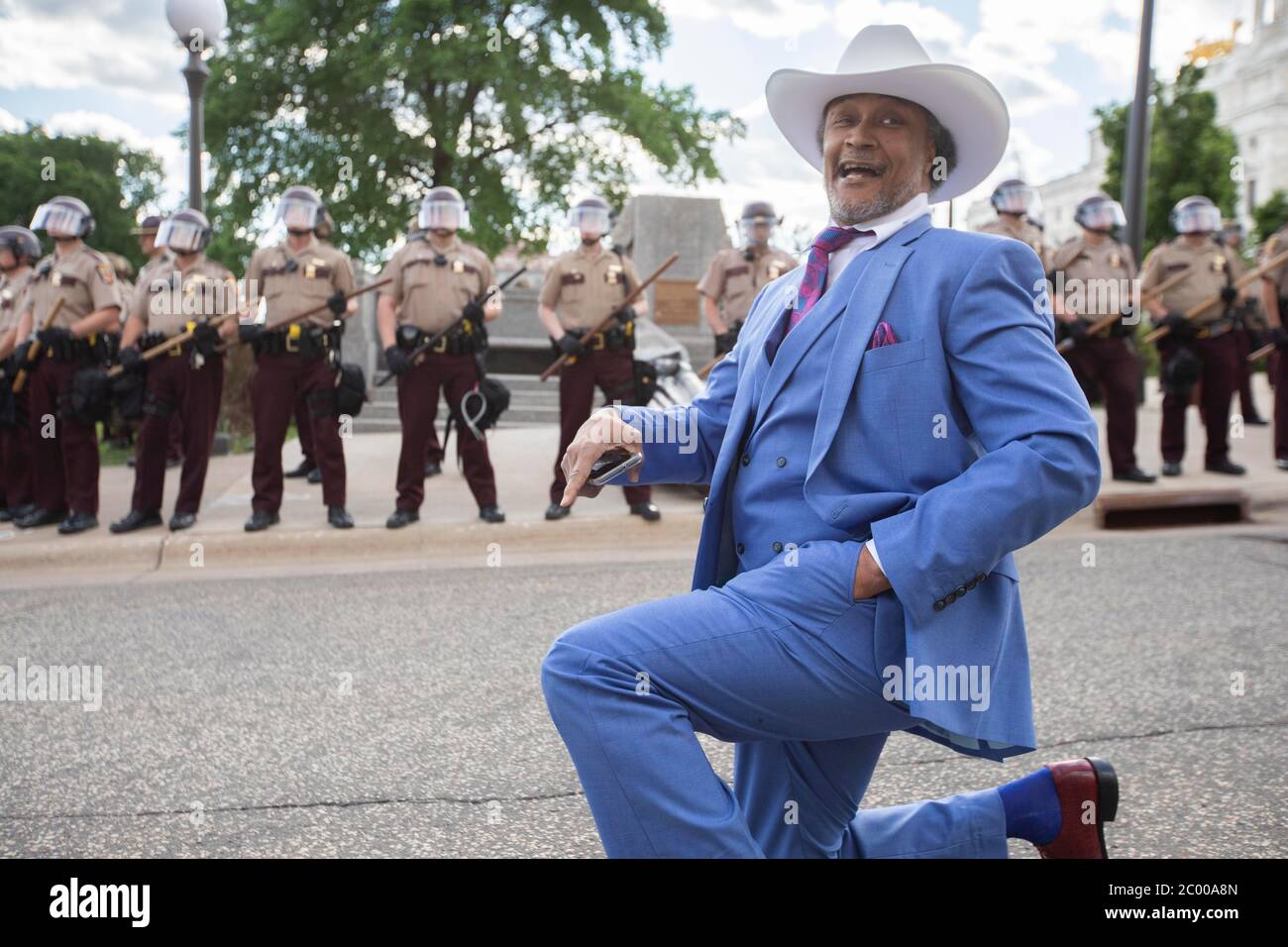 June 10, 2020: Rickey Jones takes a knee as State Troopers in the back ...
