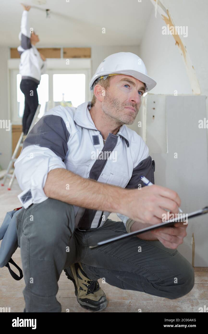engineer using clipboard to write something while working indoors Stock ...
