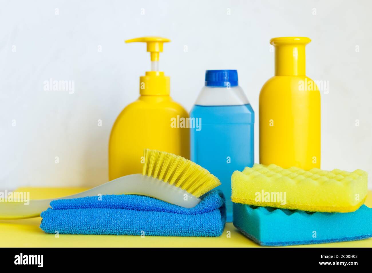 Cleaning concept with various plastic bottles and canisters on white ...