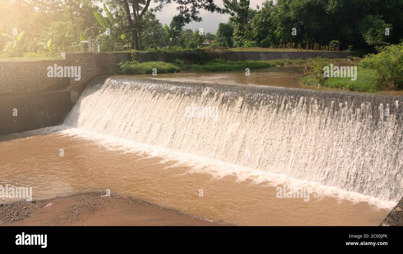 Dam with a little water discharge after flooding Stock Photo - Alamy