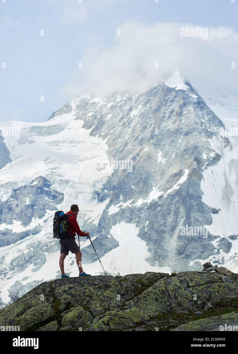 Vertical snapshot of backpacker walking with trekking poles. Amazing ...