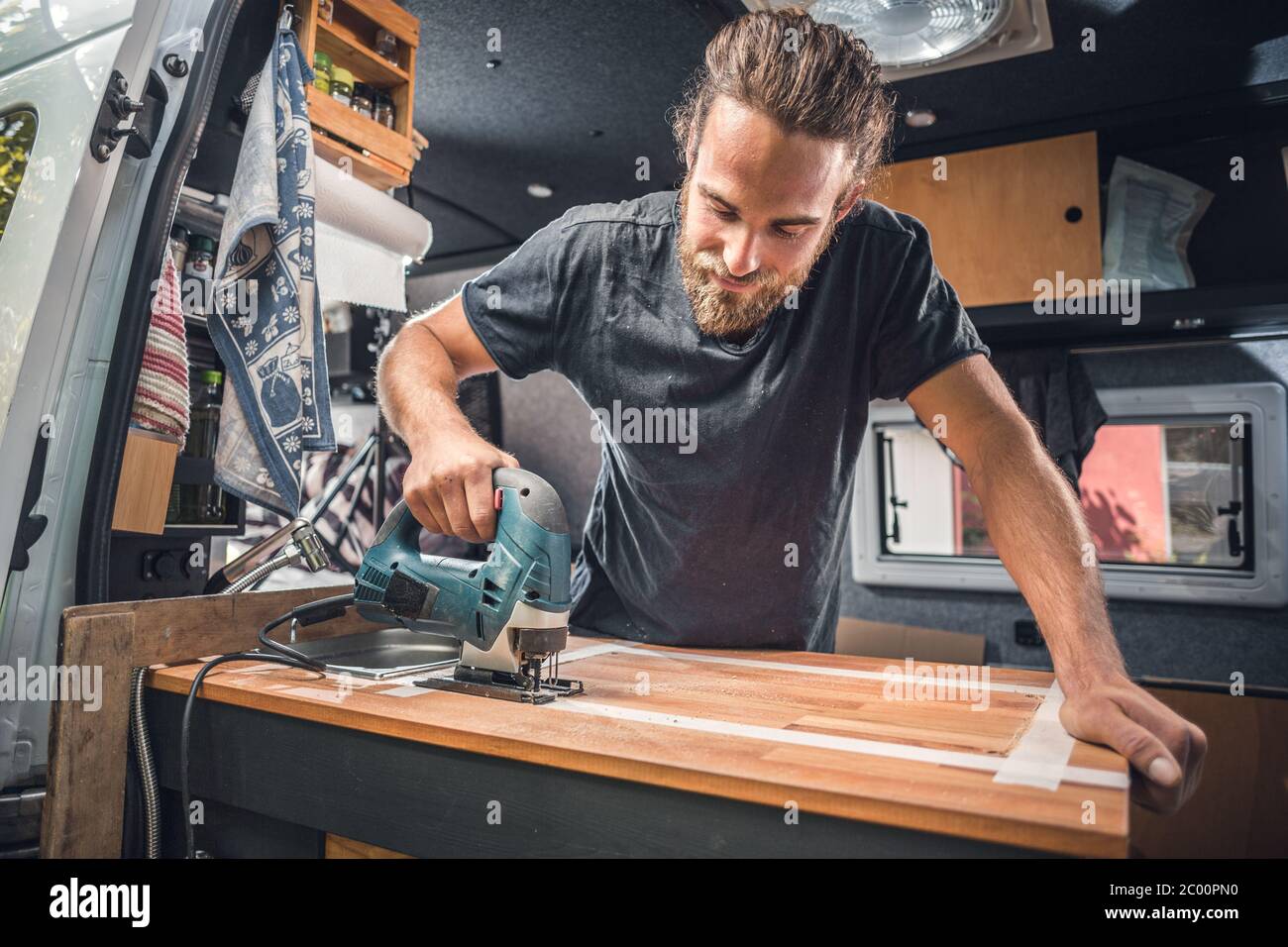 Man working on his camper van conversion Stock Photo - Alamy