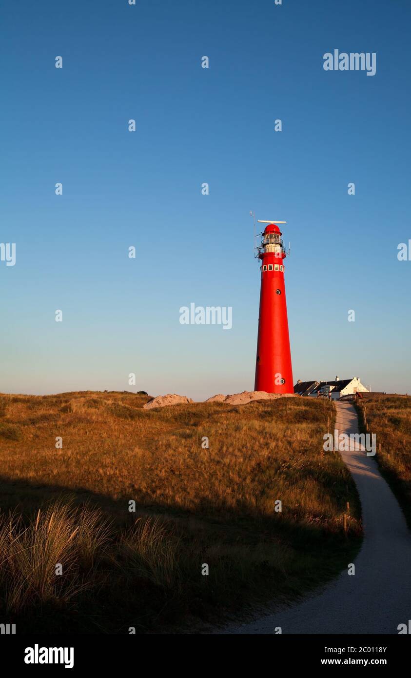 path to red lighthouse before sunset Stock Photo - Alamy