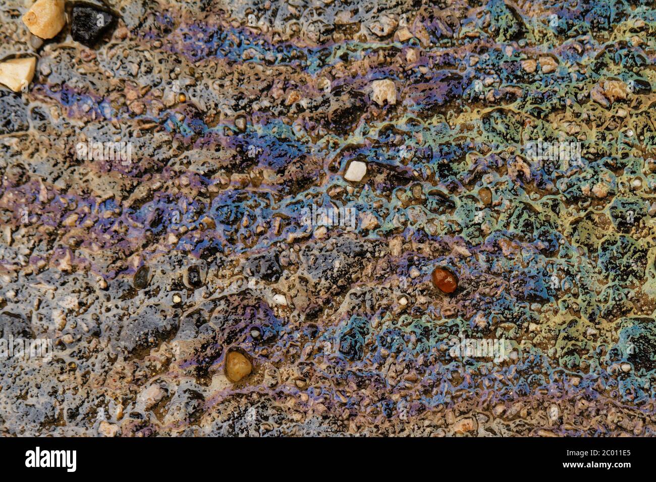 Photo of colorful oil spill on the road Stock Photo - Alamy