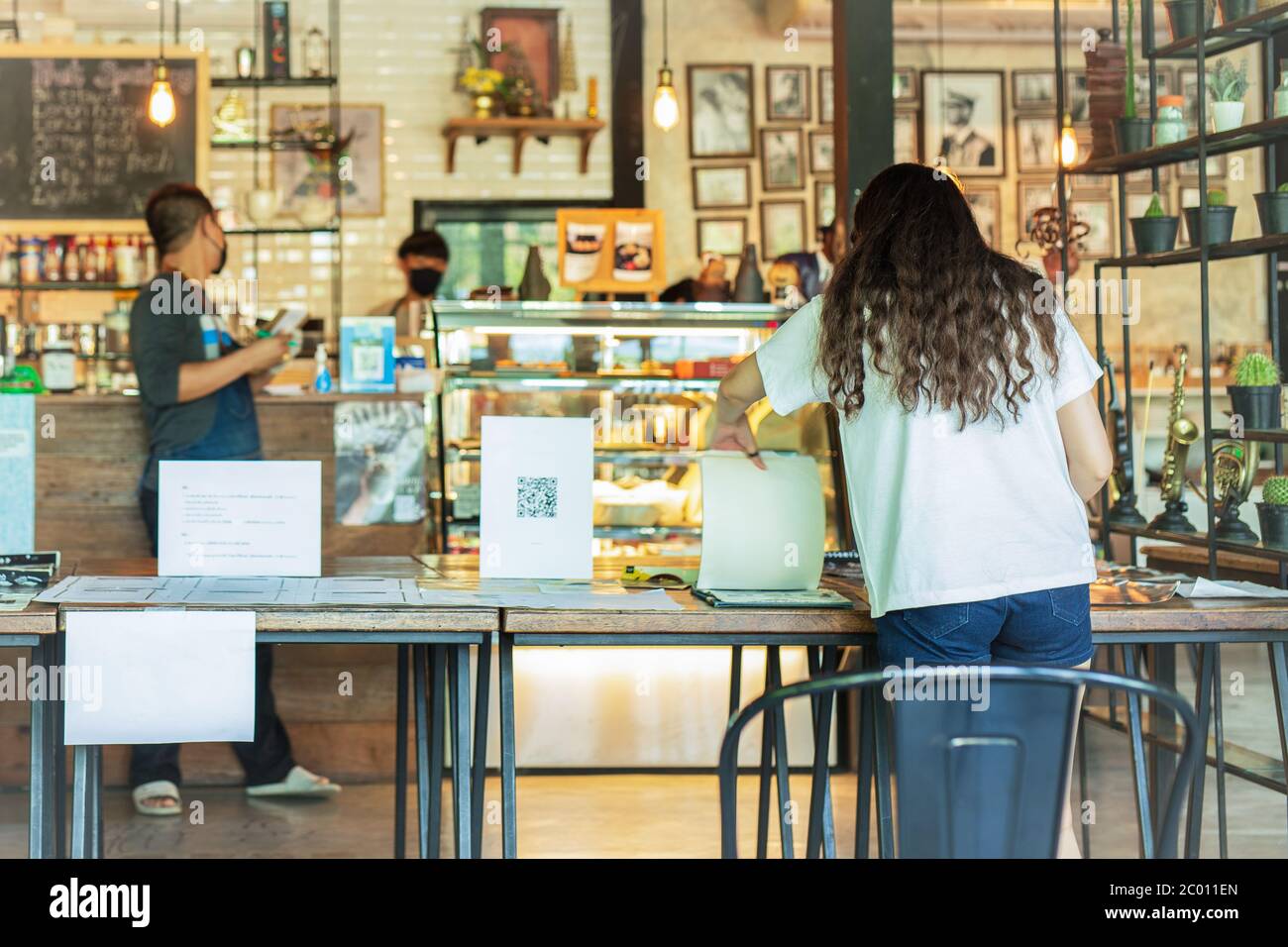 Social distance conceptual woman customer looking at menu with in cafe ...