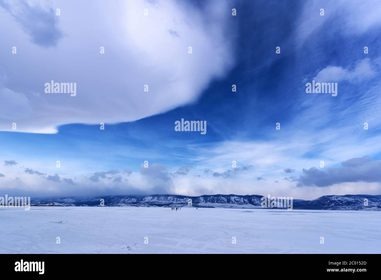 Frozen Lake Baikal. Beautiful stratus clouds over the ice surface on a ...