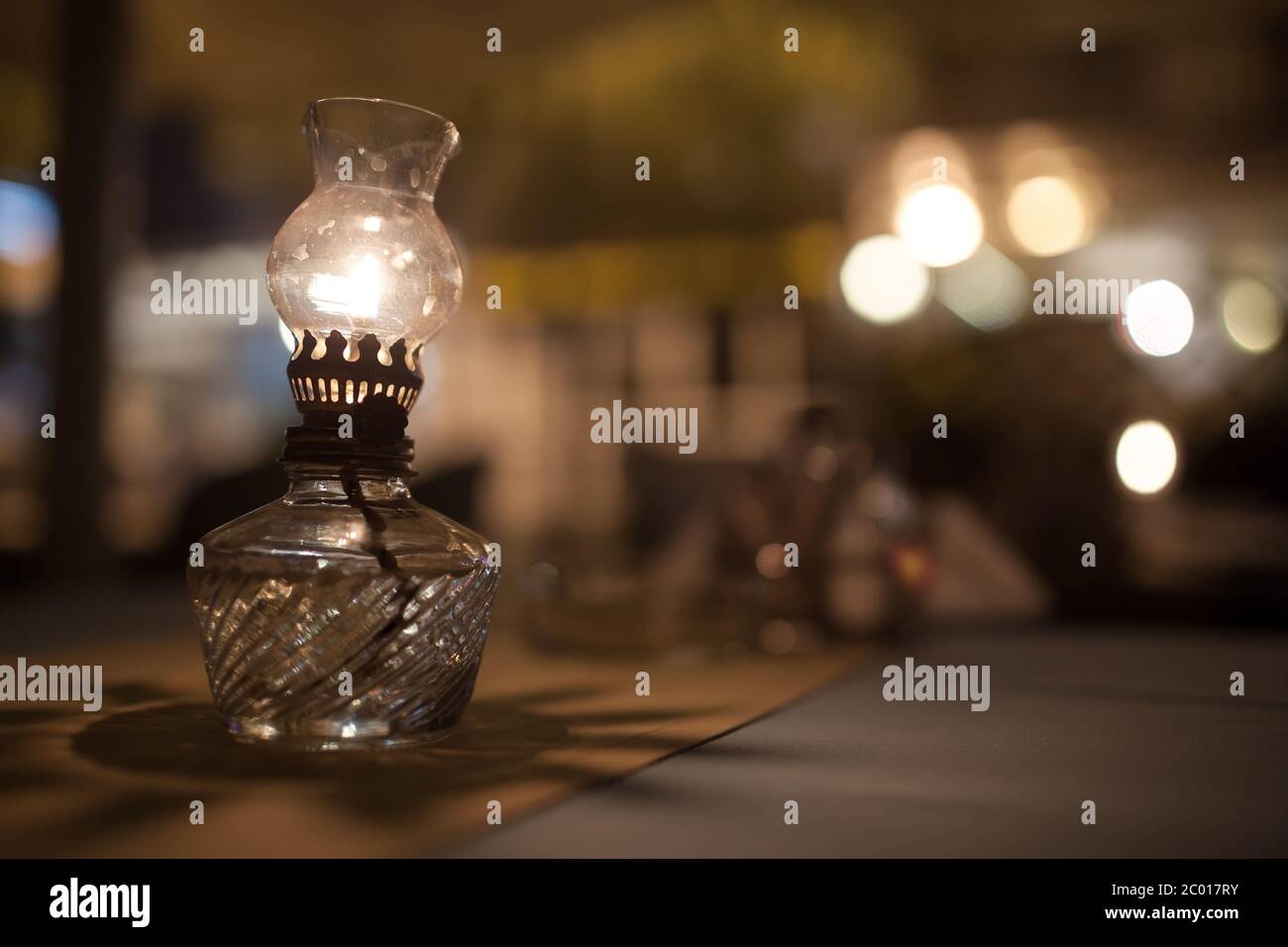 Antique oil lamp with dim light on table in cafe Stock Photo - Alamy