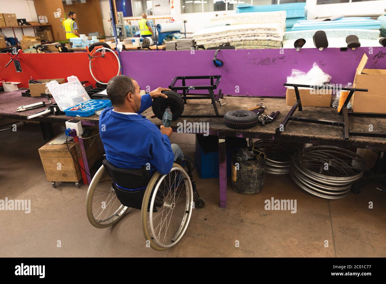 Worker assembling a wheelchair parts Stock Photo - Alamy