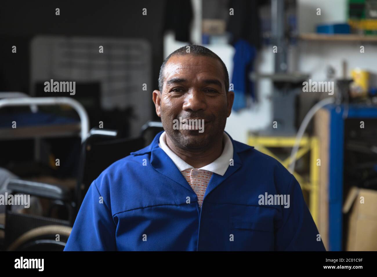 Portrait of a worker building wheelchairs Stock Photo - Alamy