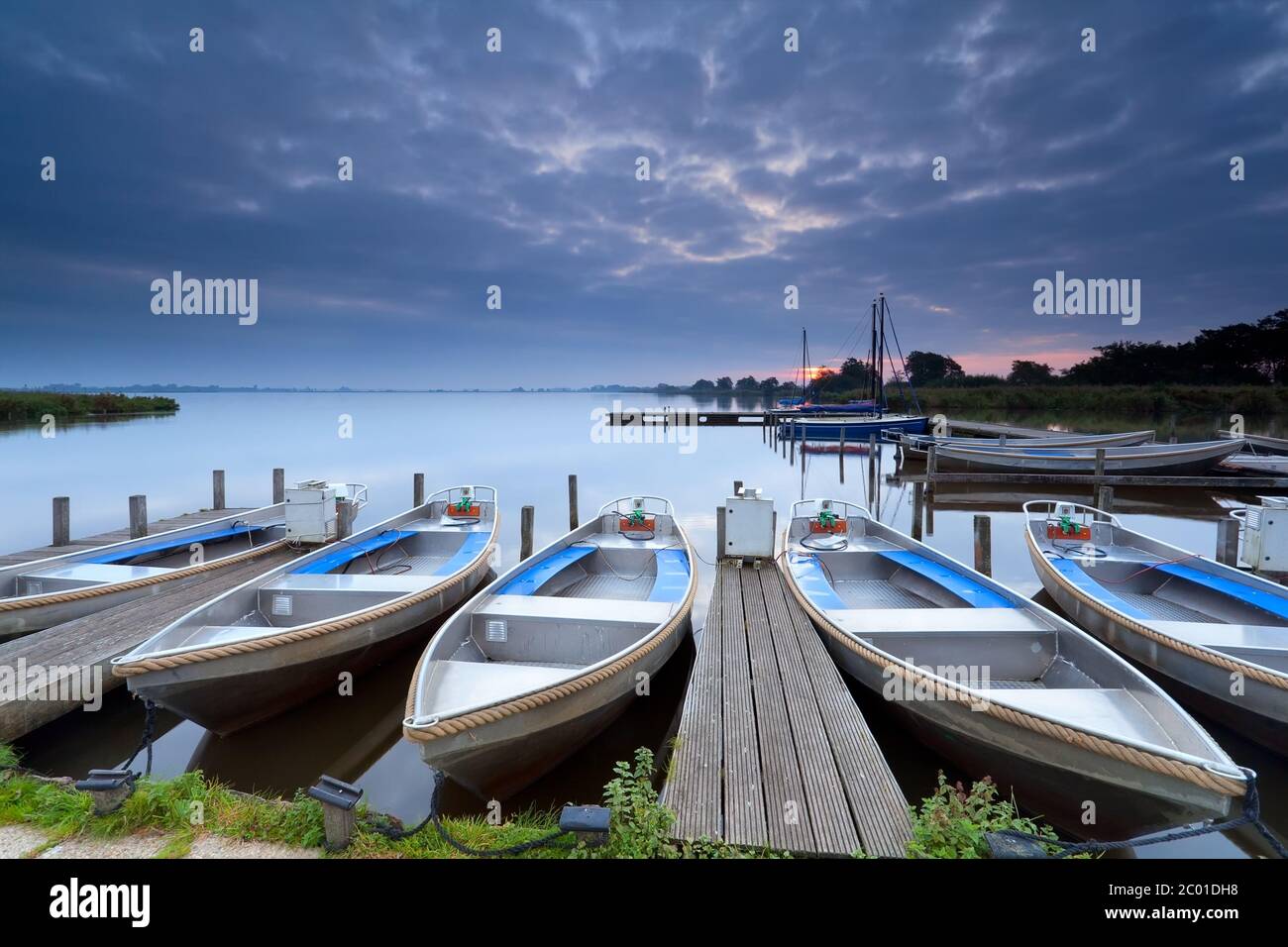 boats on lake harbor at sunrise Stock Photo - Alamy