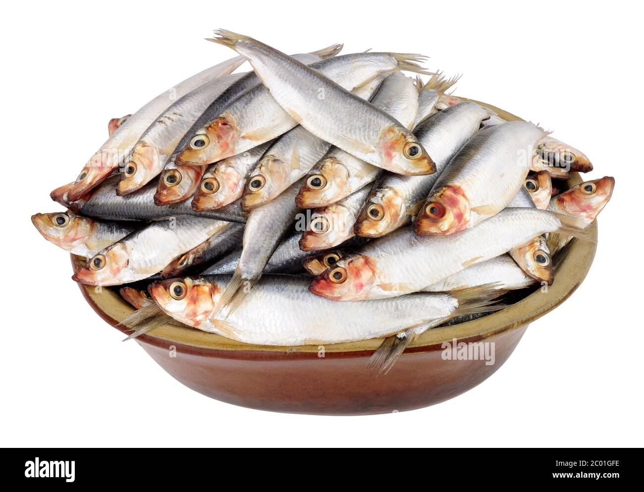 Rustic dish filled with fresh raw fish sprats isolated on a white ...