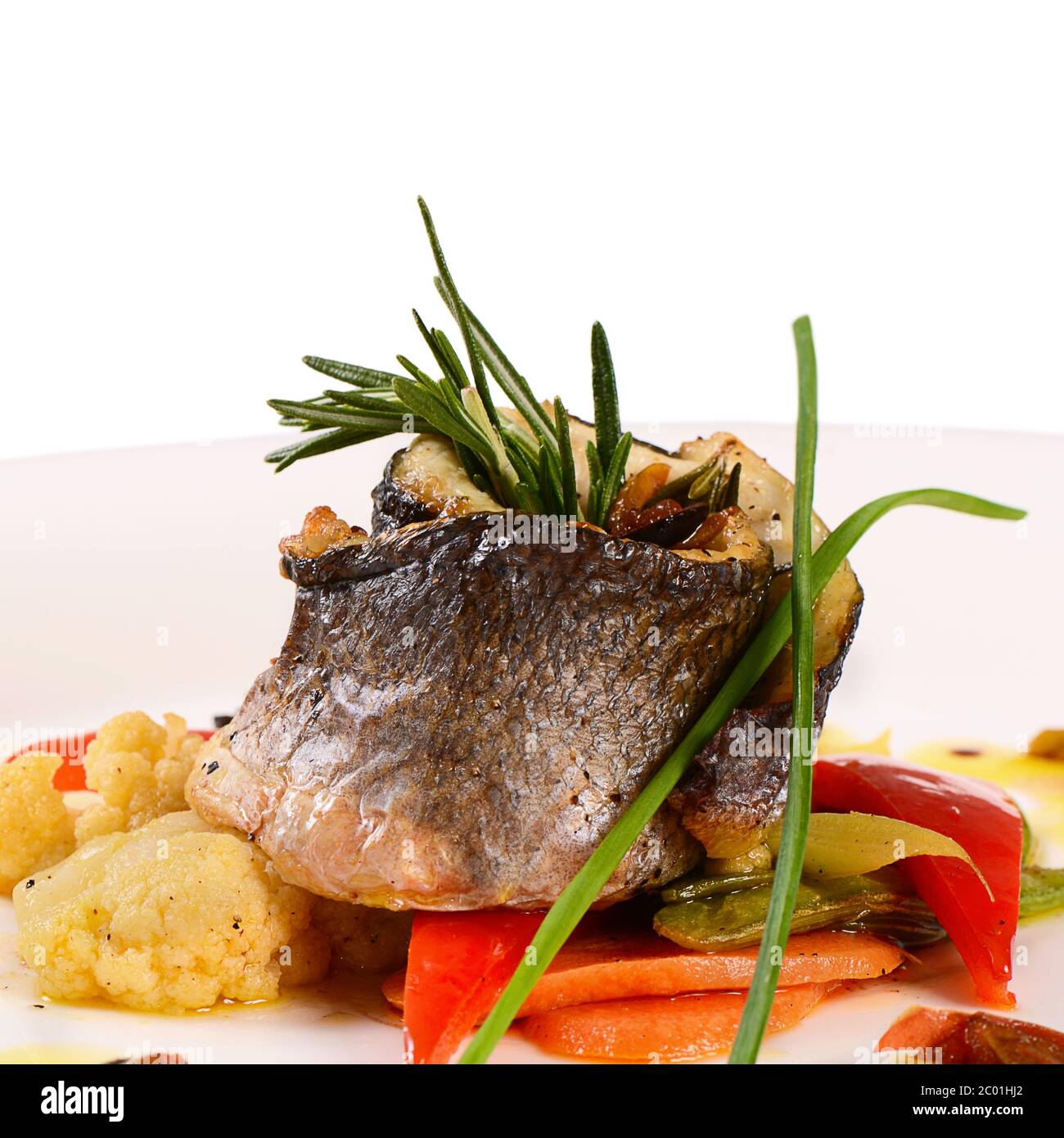 Sea bass fillet with spring vegetables Stock Photo - Alamy