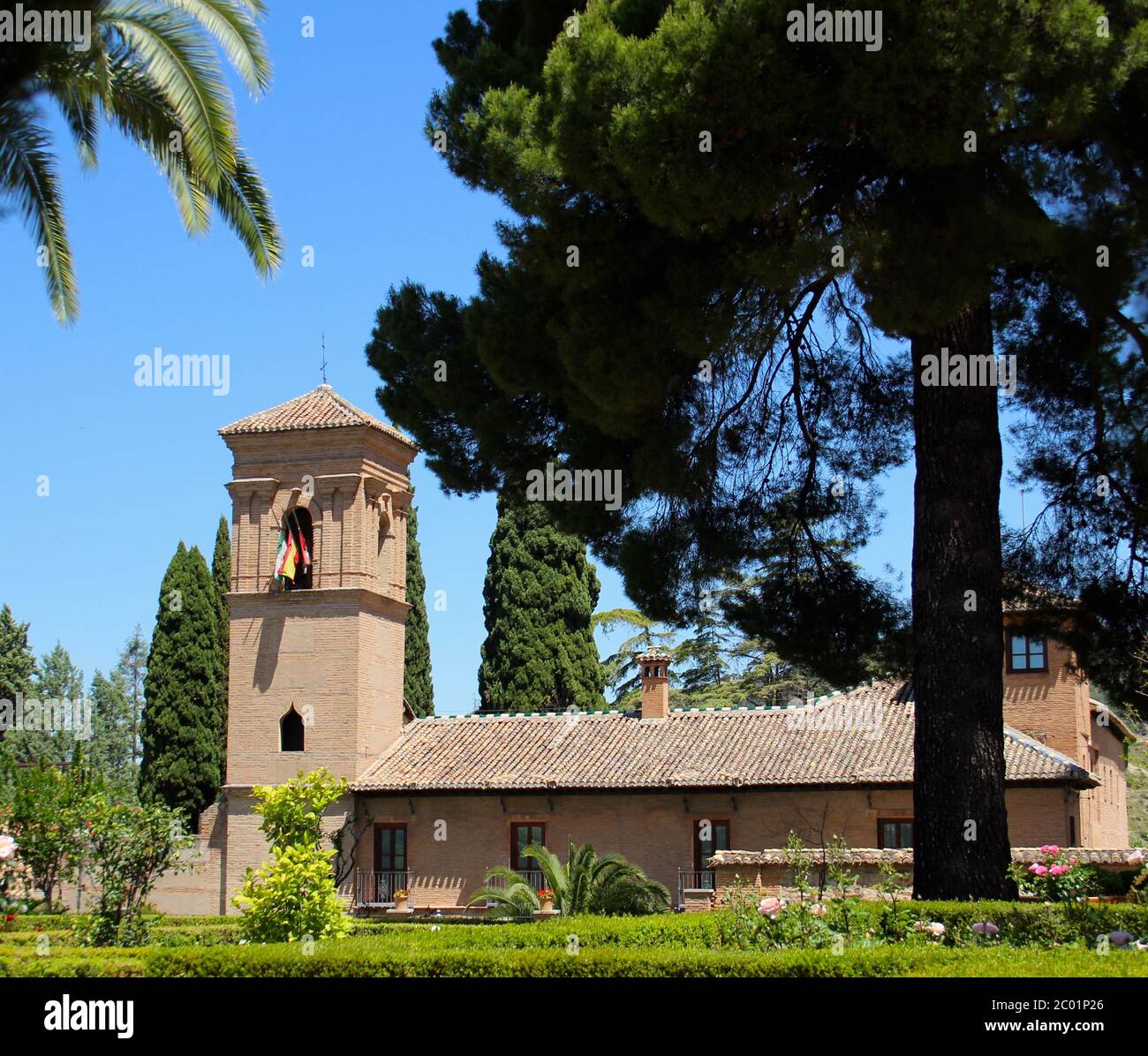 View of the Parador from the gardens in the Alhambra on a hot sunny day ...