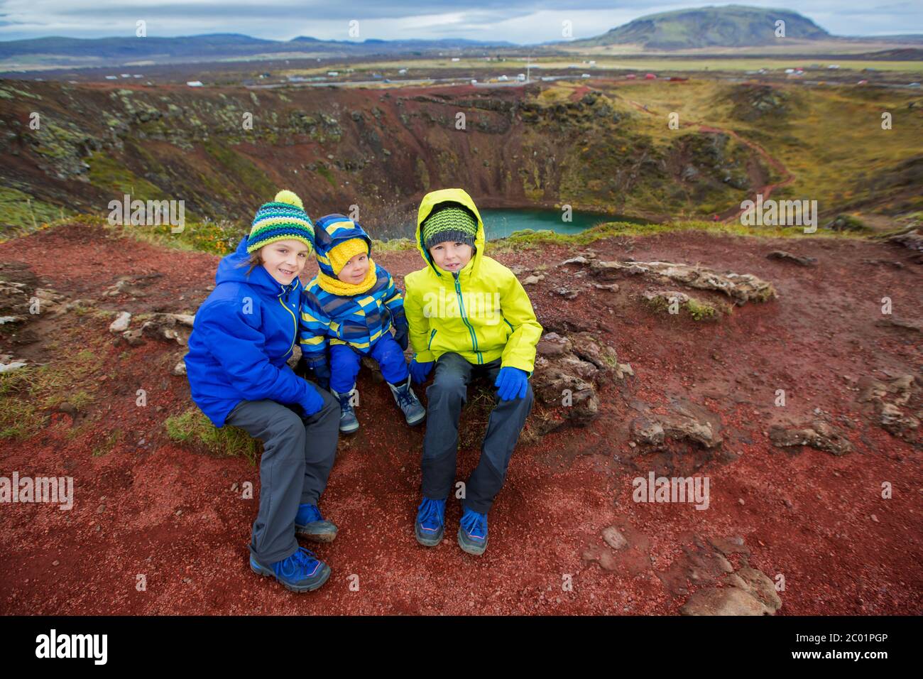 Children, boys, posing in front of Kerid crater lake in Iceland ...