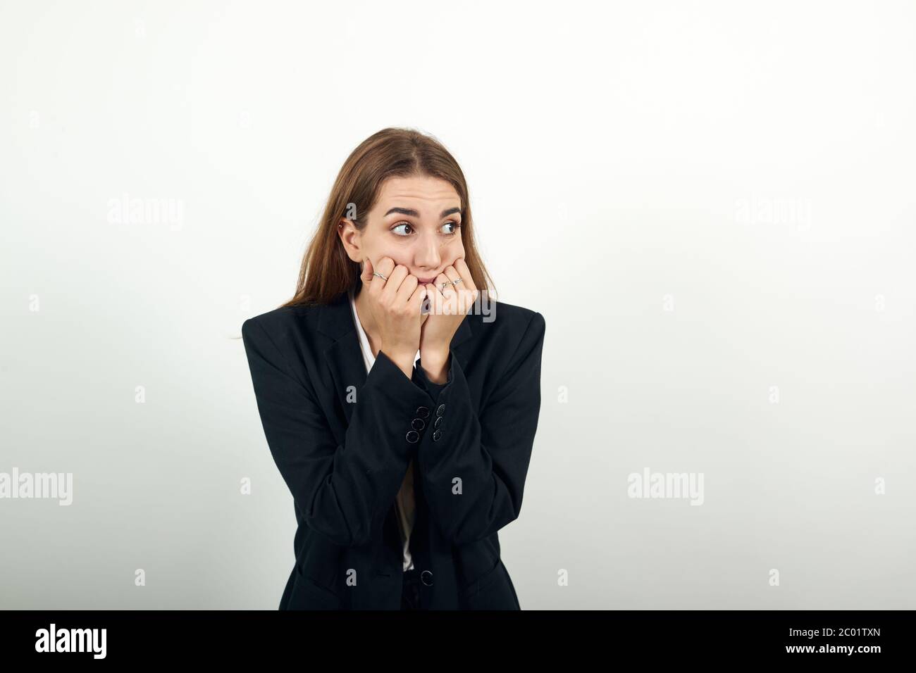 Image of scared, biting fists emotionally. Covering mouth behind ...