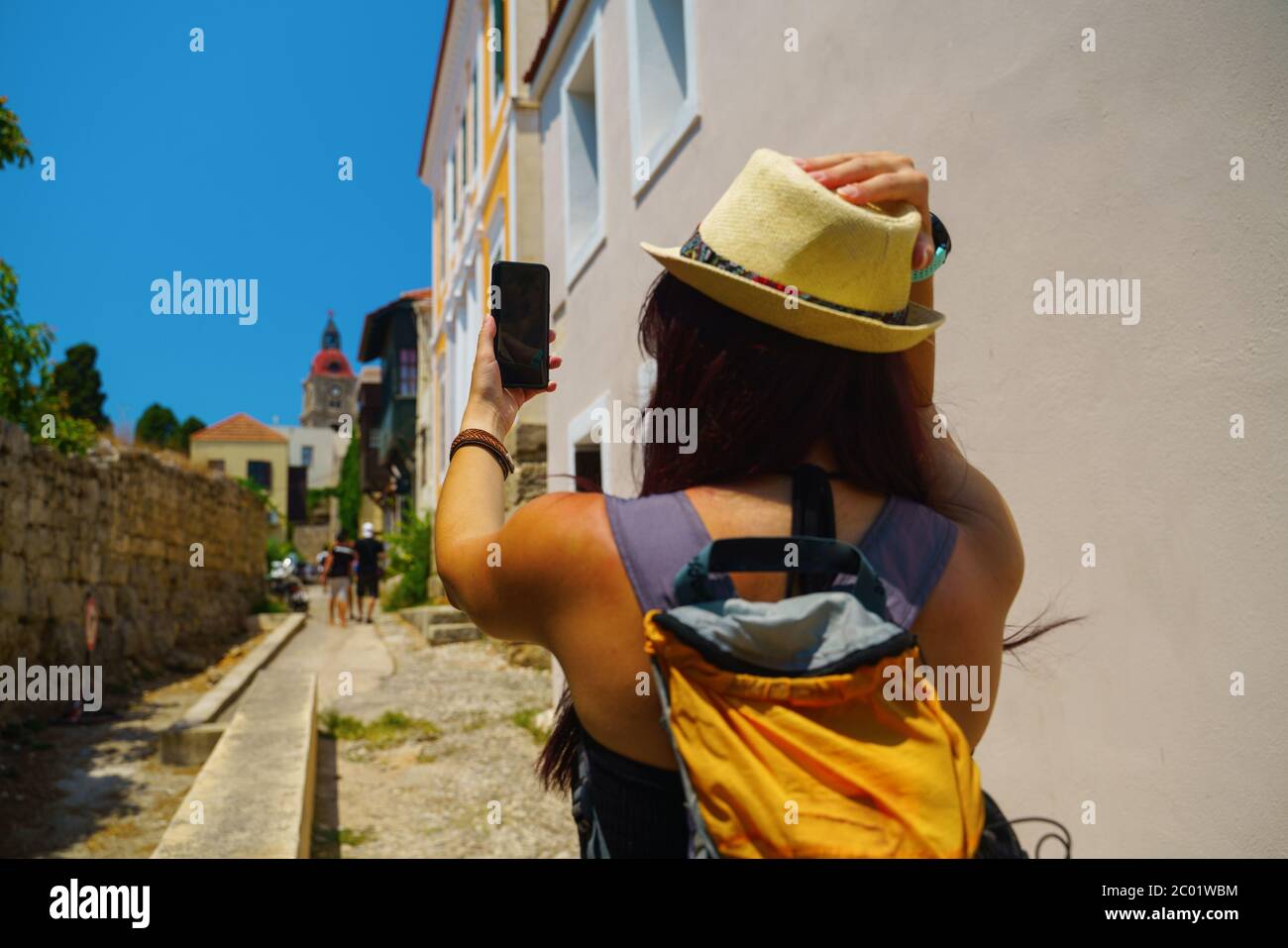 Happy woman traveler is walking and taking selfie photo on phone on ...