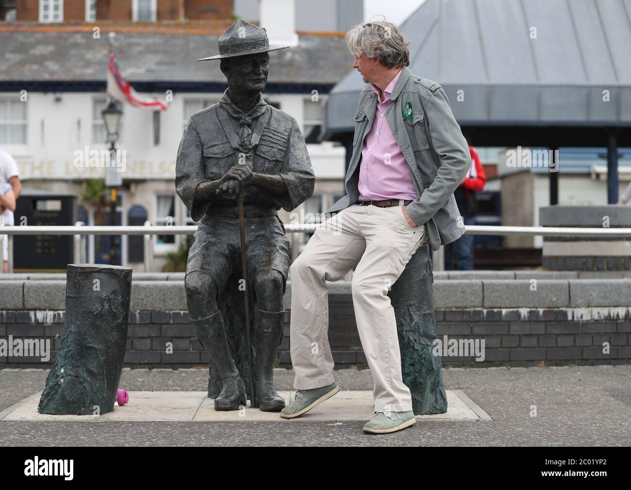 Mark Howell, Deputy leader of BCP Council, sits next to a statue of ...