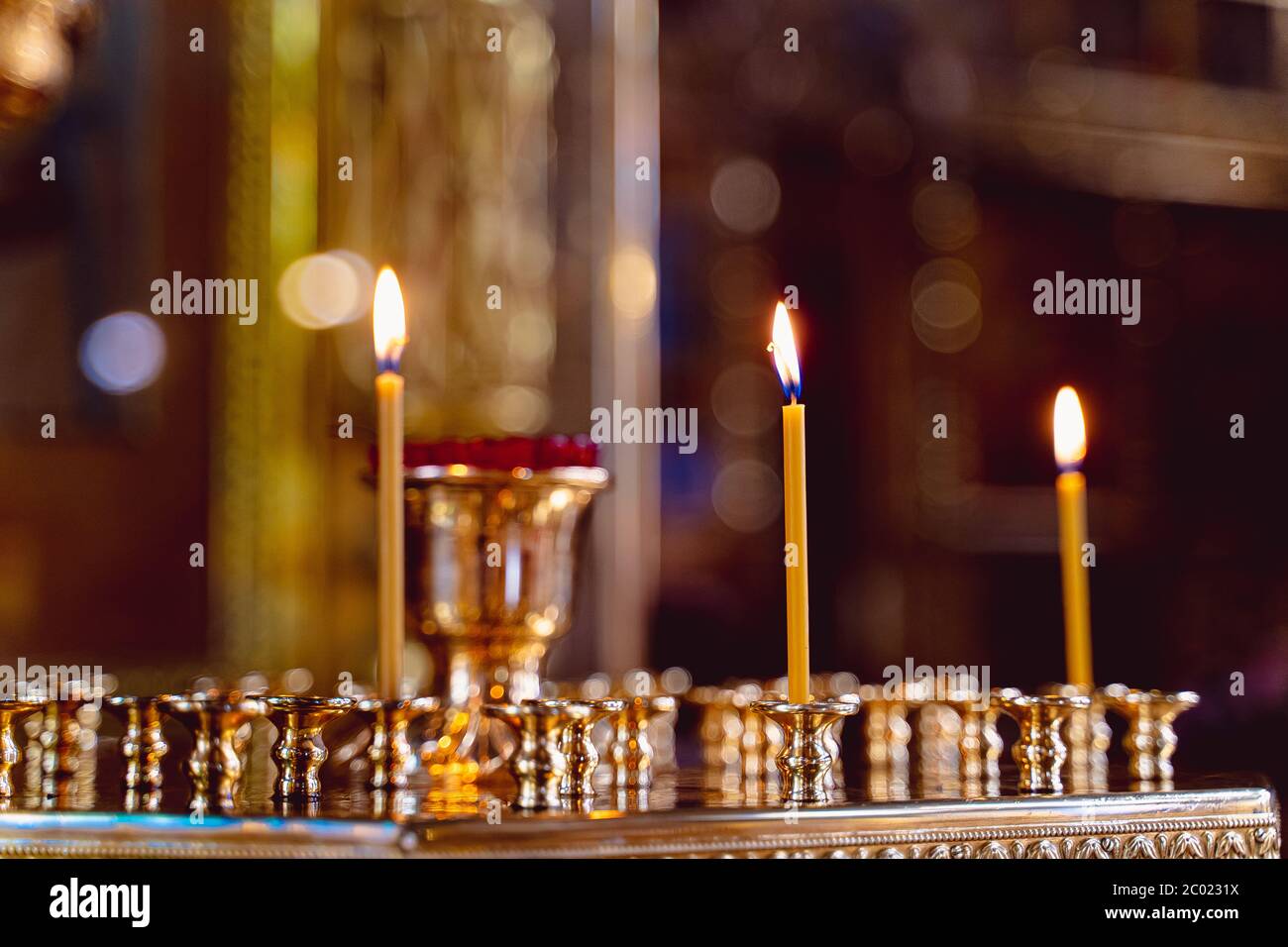 candles in the candlestick in the temple Stock Photo - Alamy