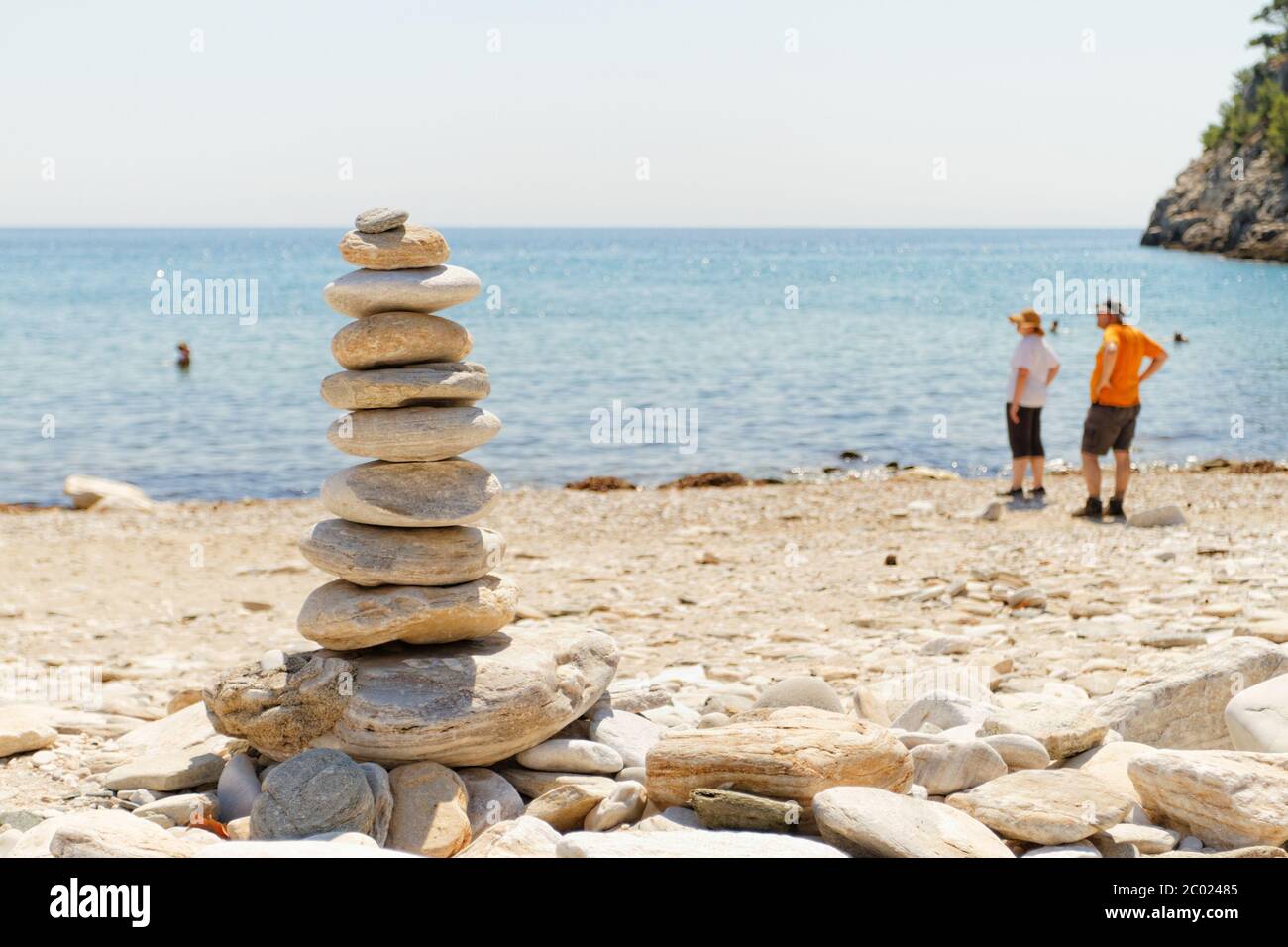 Photo of a tall stone sculpture in the beach Stock Photo - Alamy