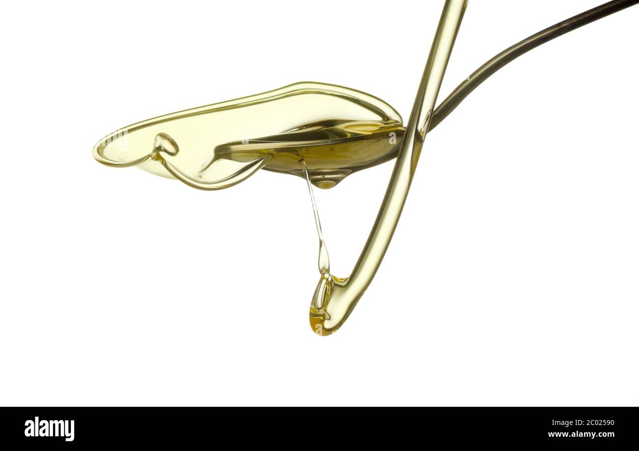 Pouring oil splash. Isolated on white background Stock Photo - Alamy