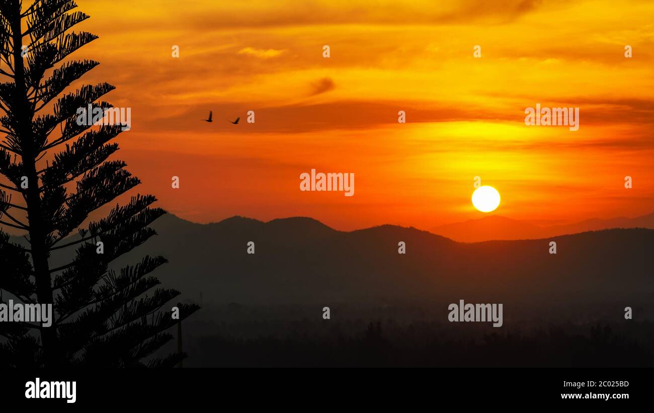 Sunset over mountain range Stock Photo - Alamy