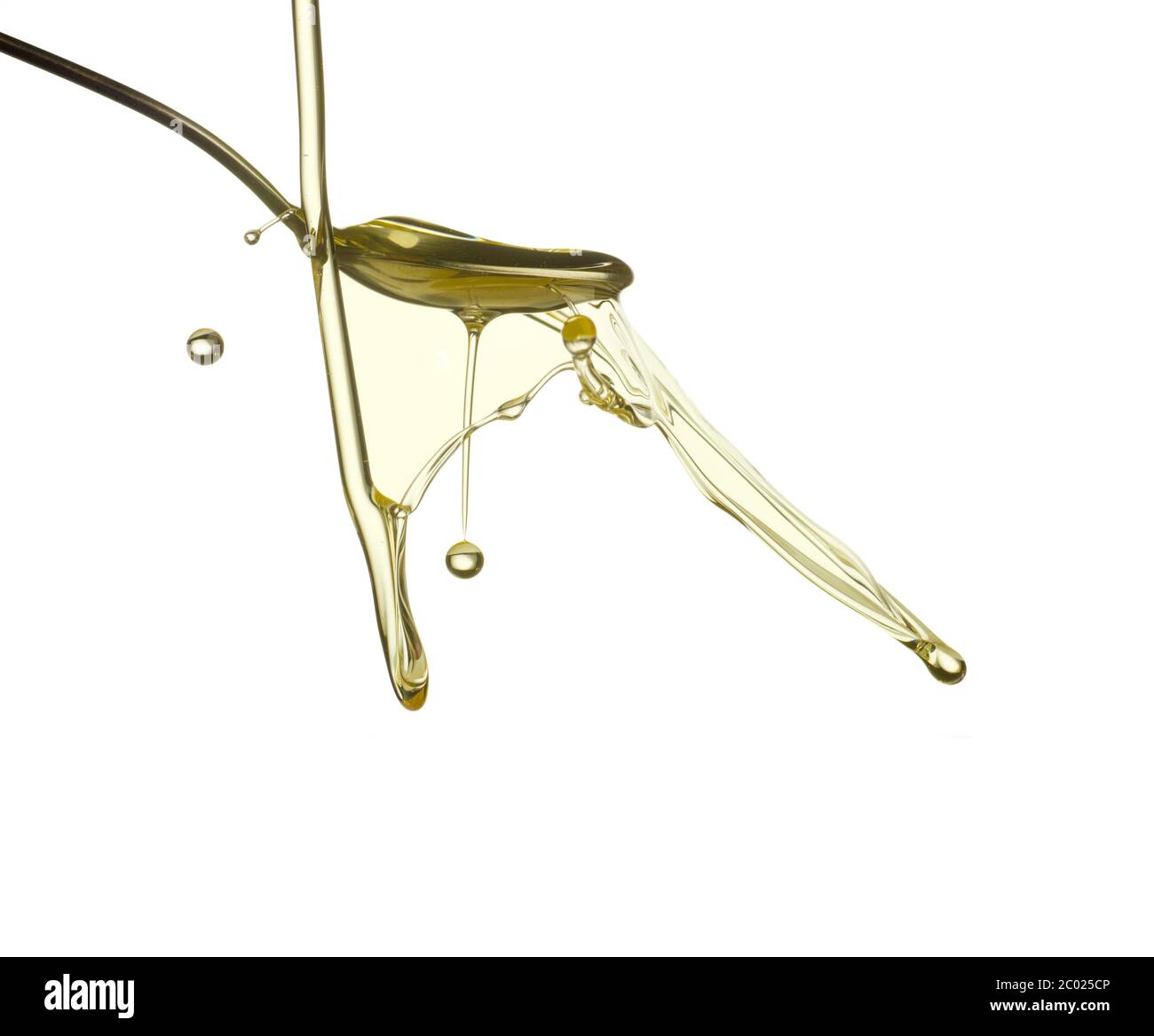 Pouring oil splash. Isolated on white background Stock Photo - Alamy