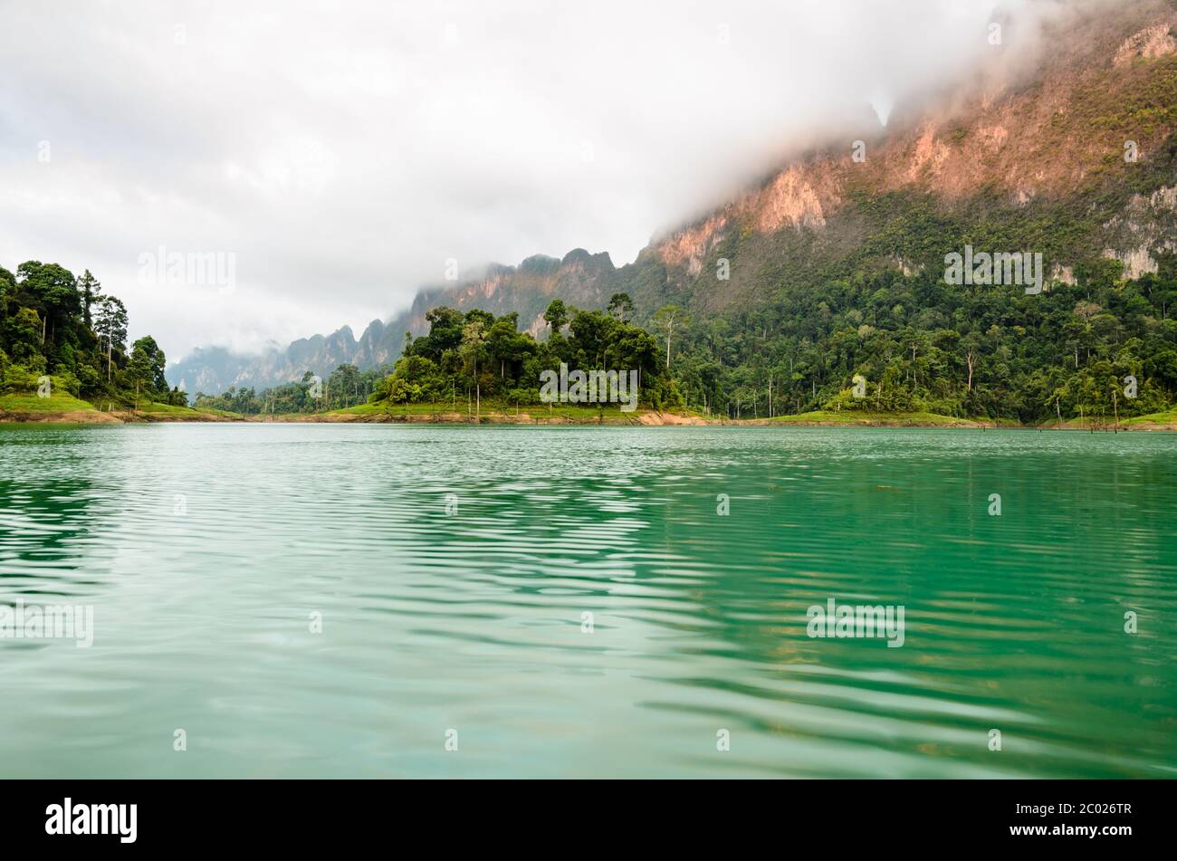 Beautiful high mountains and green lake Stock Photo - Alamy