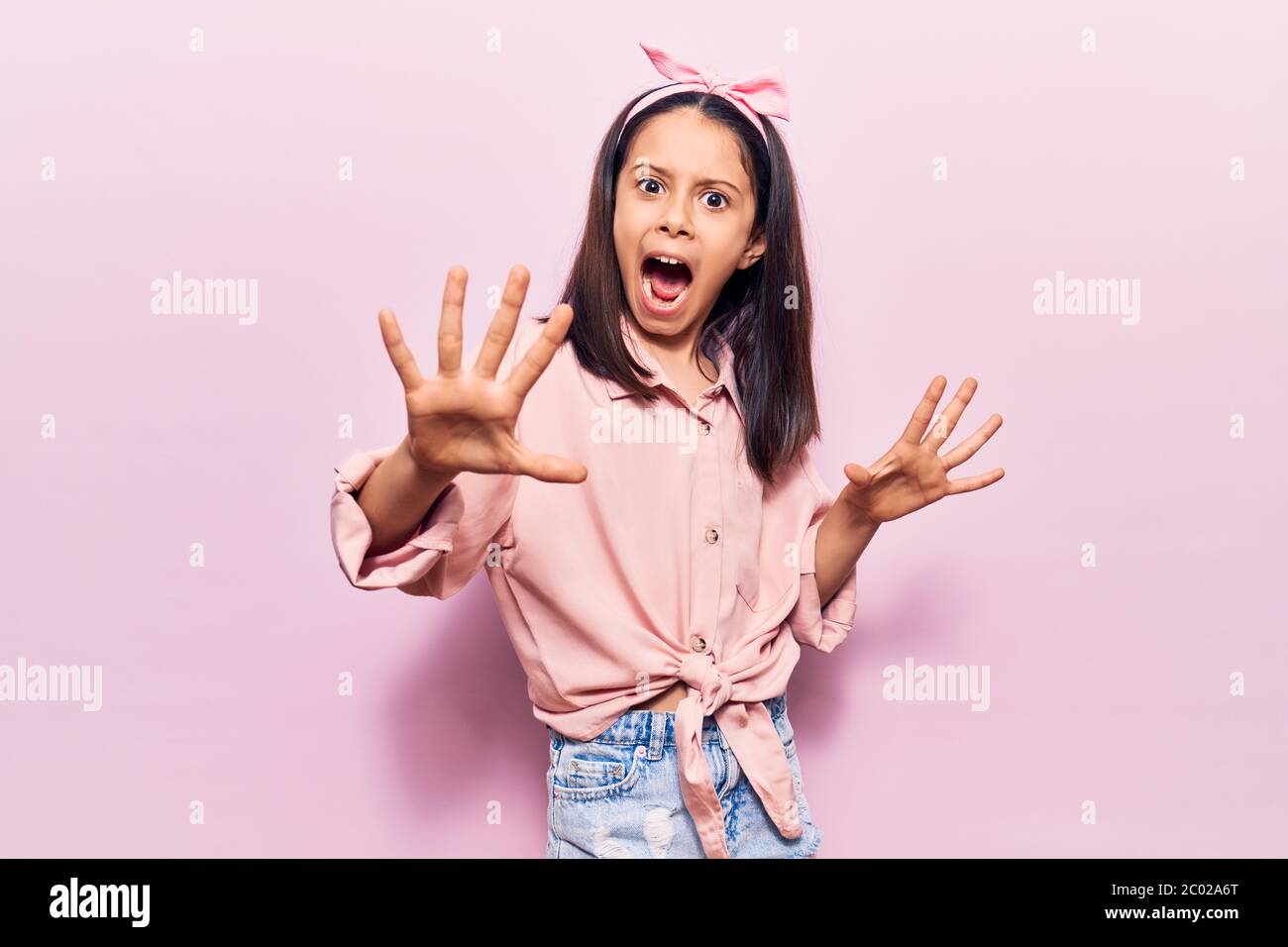 Beautiful child girl wearing casual clothes afraid and terrified with ...