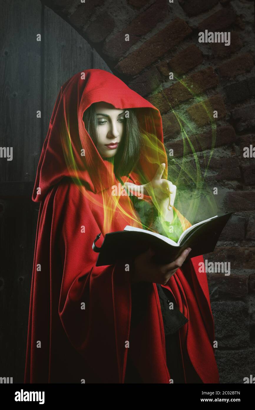 Red hooded woman reading a magical book . Dark fantasy portrait Stock ...
