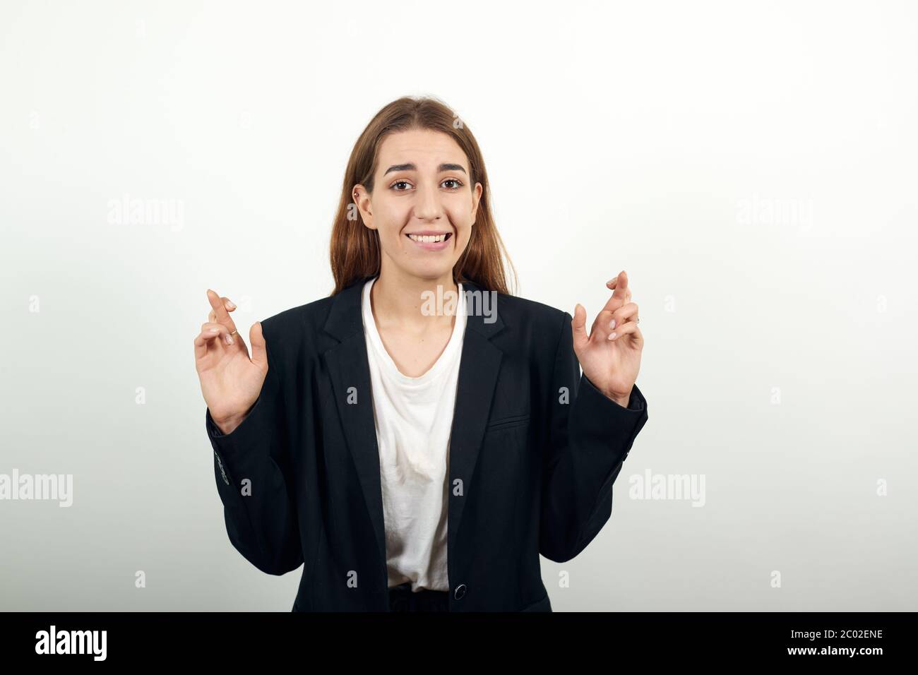 Crosses fingers, prays before important occasion, wishes luck, hopes in ...