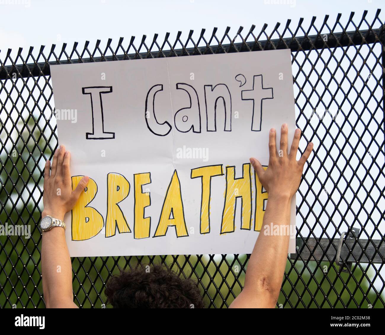 Washington, DC, USA. 10th June, 2020. A man shows a protest sign near ...