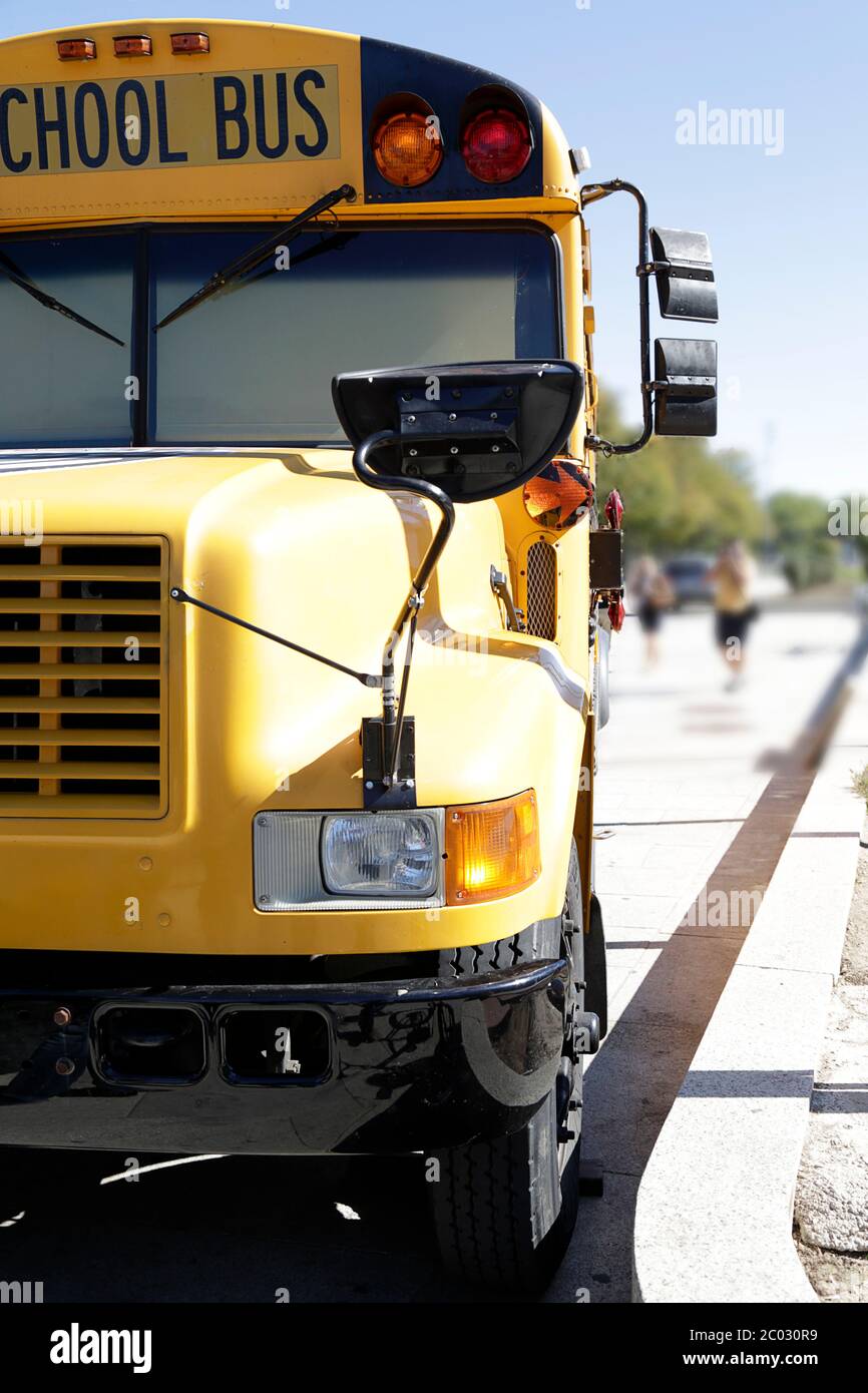 Traditional yellow school bus on the street Stock Photo - Alamy