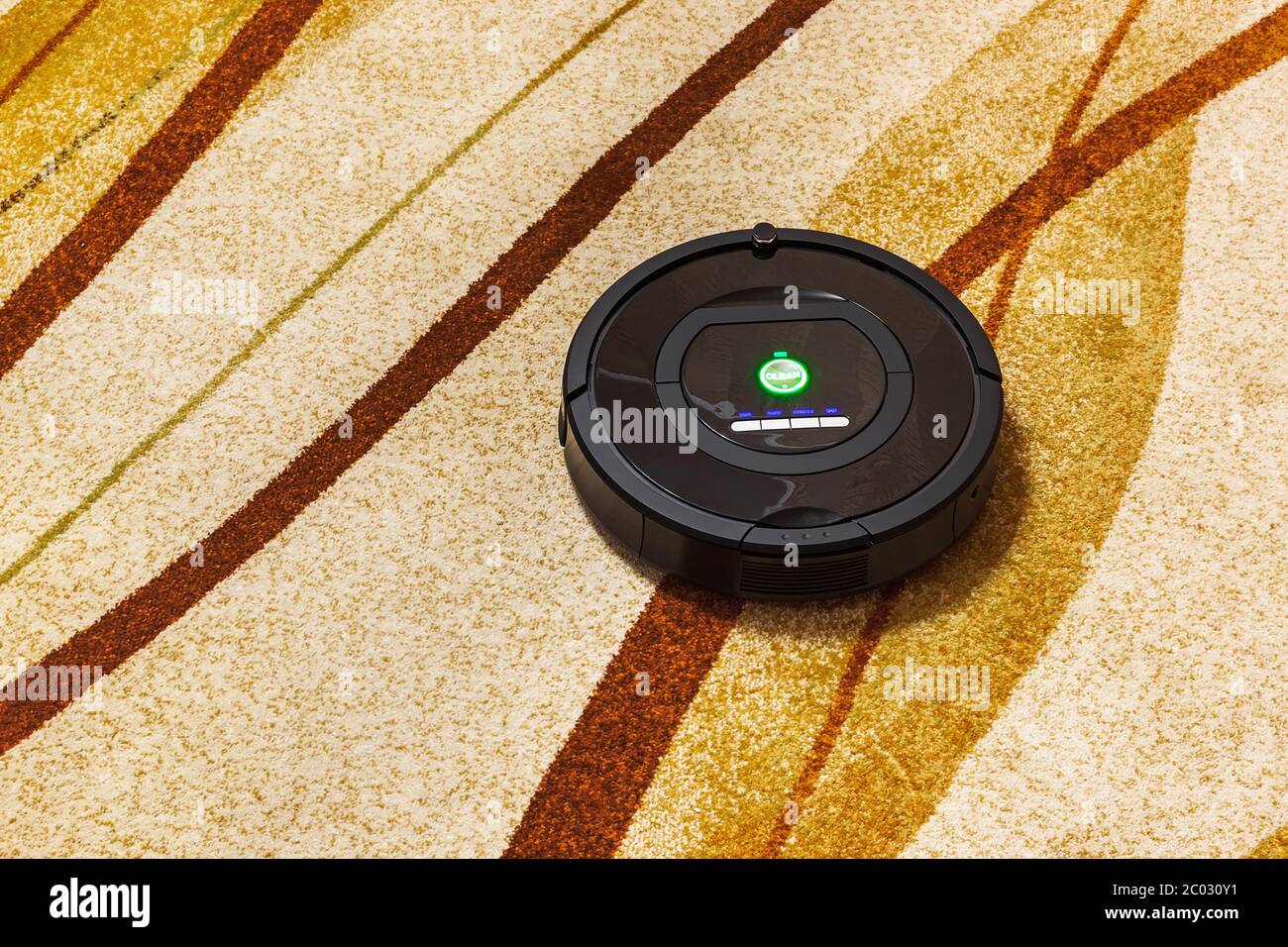 Robotic vacuum cleaner on carpet Stock Photo - Alamy