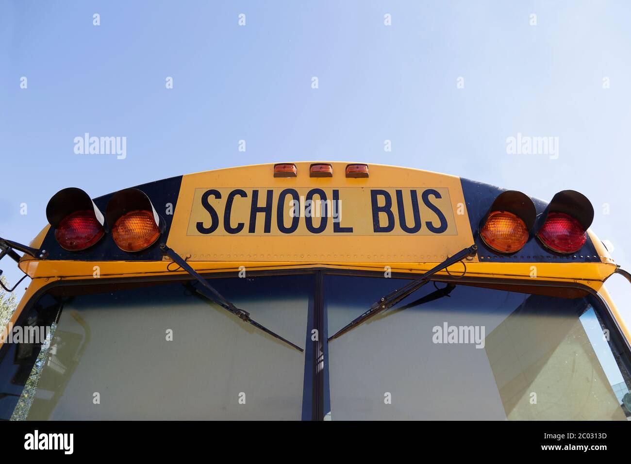 Traditional yellow school bus on the street Stock Photo - Alamy