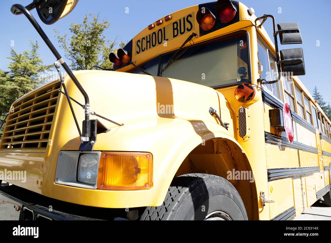 Traditional yellow school bus on the street Stock Photo - Alamy