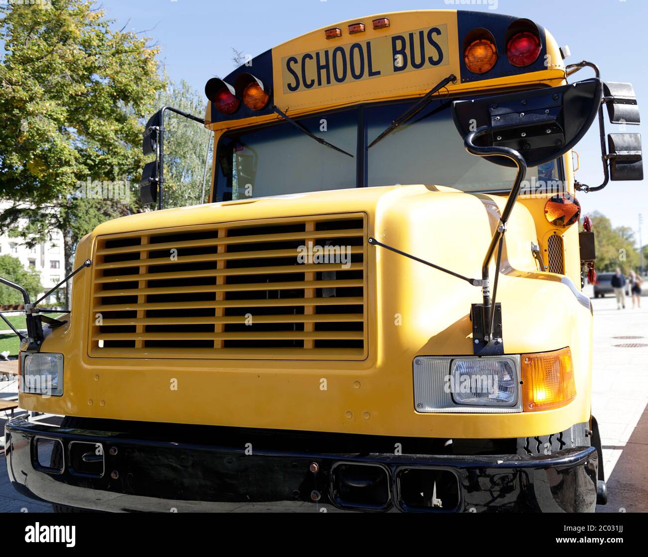 Traditional yellow school bus on the street Stock Photo - Alamy