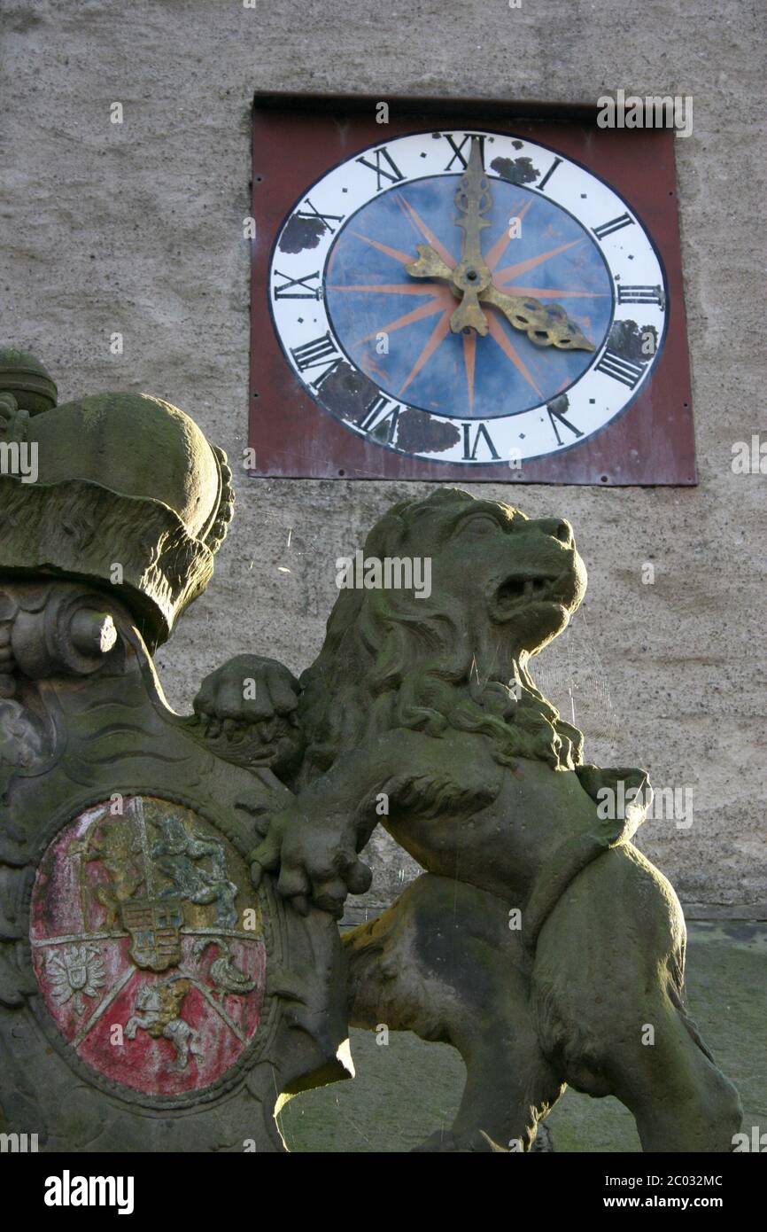 Lion in front of a tower clock Stock Photo - Alamy