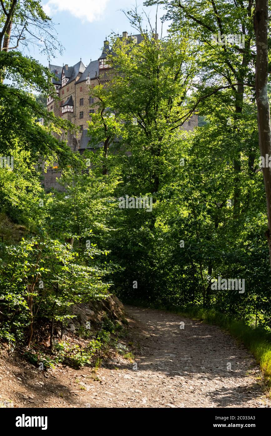 Hiking path in the forest with Burg Eltz in the background on a spring ...