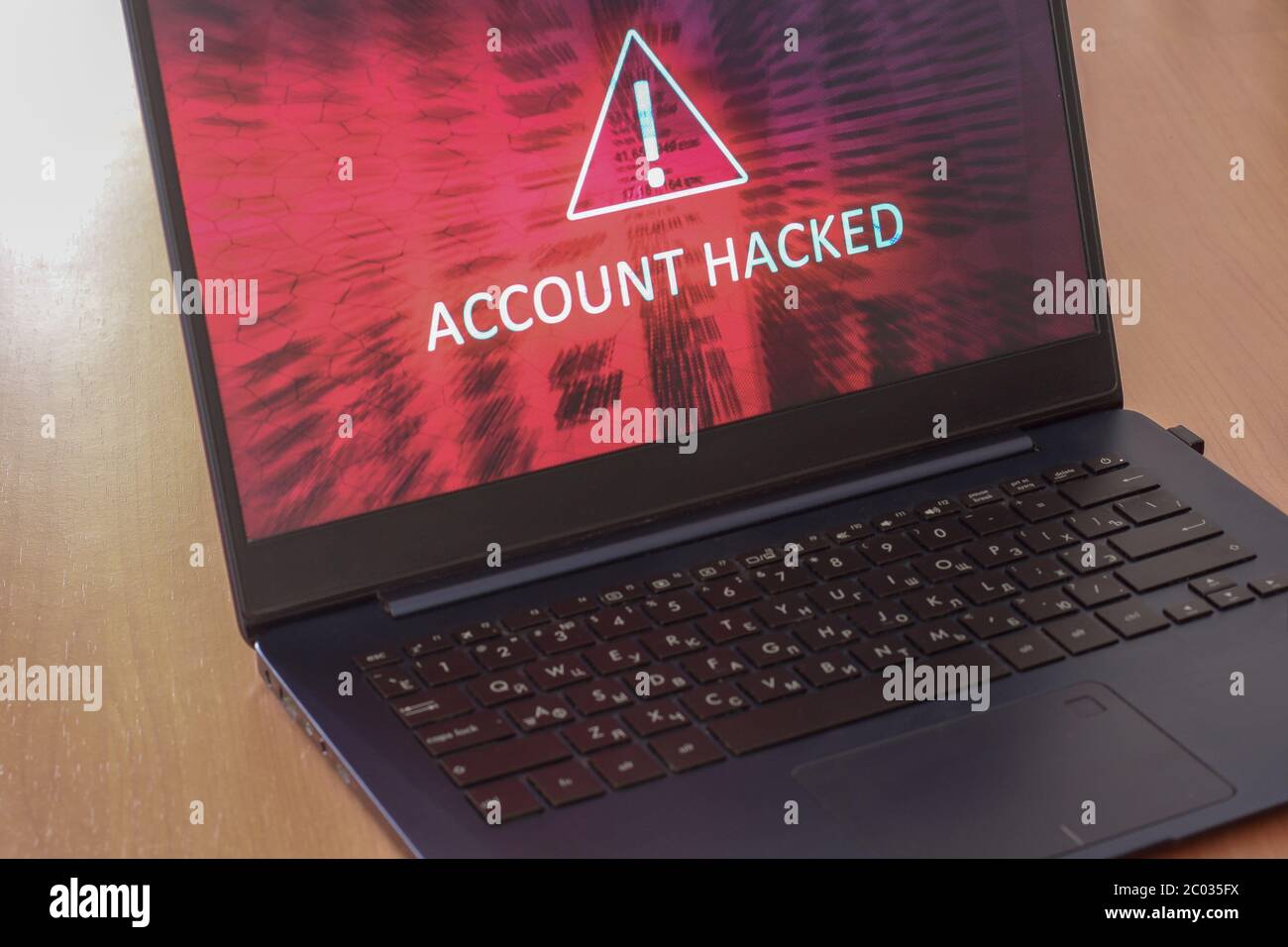 Hacked account concept on laptop screen with red background. Warning ...