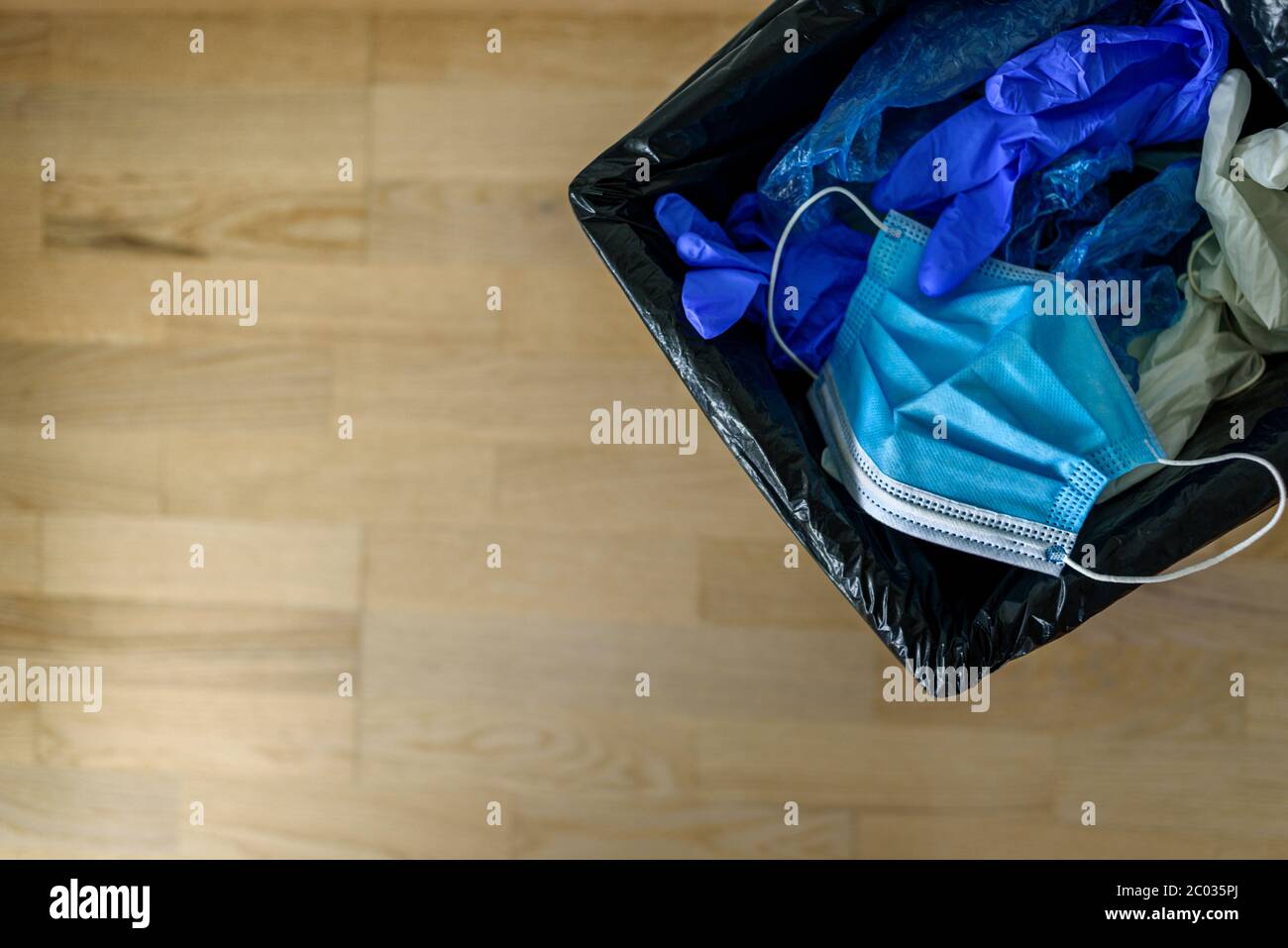 Waste container with medical garbage - face mask, gloves in hospital ...