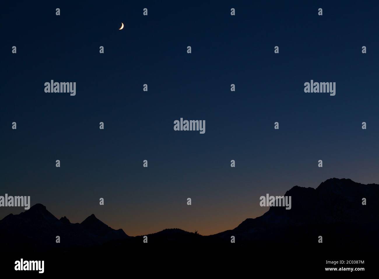 moon over mountain range at night Stock Photo - Alamy