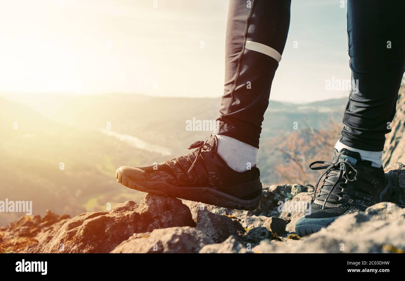 Muscular calves of fit male jogger training for cross country rocks ...