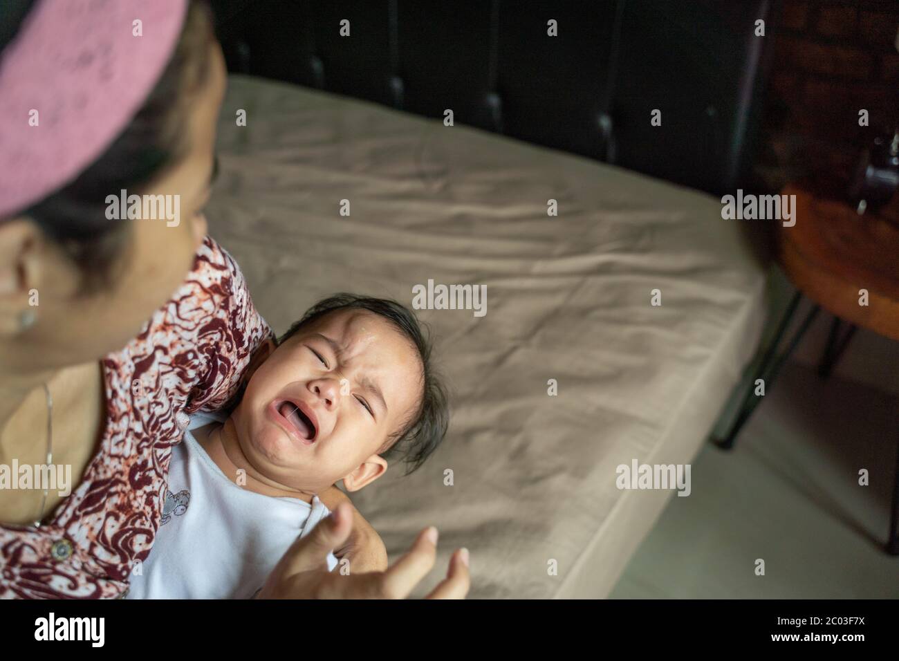 asian baby with swollen forehead after falling from bed Stock Photo - Alamy