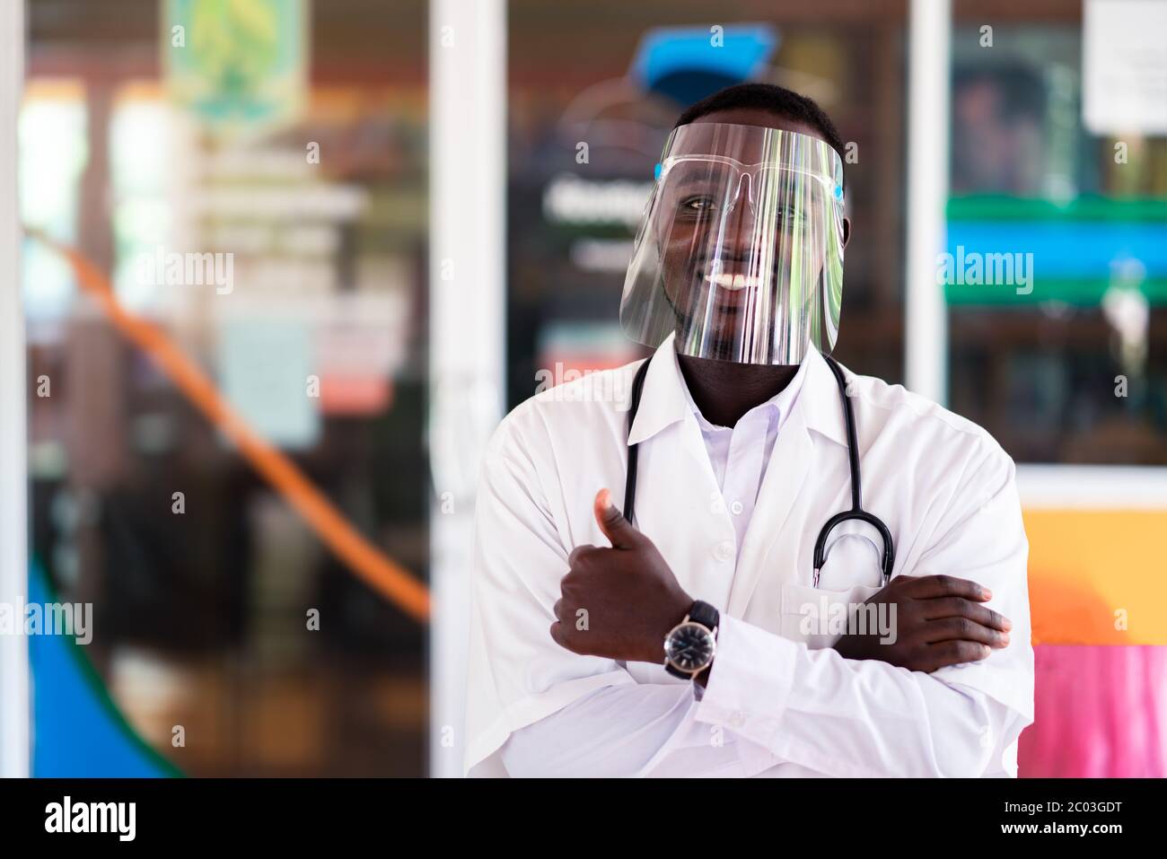 African doctor wear face shield and holding stethoscope with show good ...